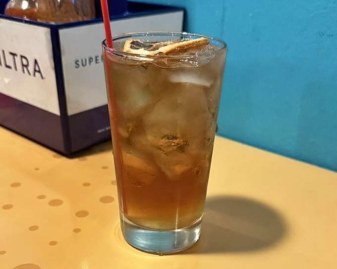 A tall glass of something refreshing that says, "You've earned this after all that spicy seafood." The ice cubes practically wink at you.