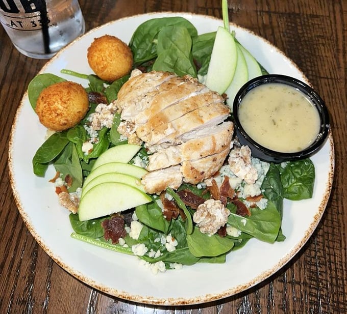 A spinach salad that makes eating greens feel like an indulgence rather than a obligation – those golden orbs are fried goat cheese, folks.