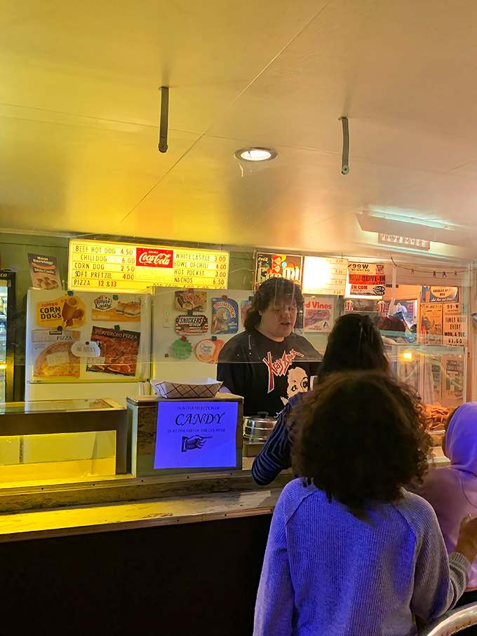 The concession stand's warm glow beckons moviegoers like moths to flame—candy, conversation, and community all served with a smile. 