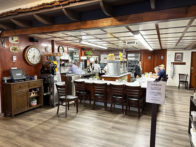 The heart of Paula's operation—where orders fly in and perfectly plated breakfasts emerge with clockwork precision and Danish charm.