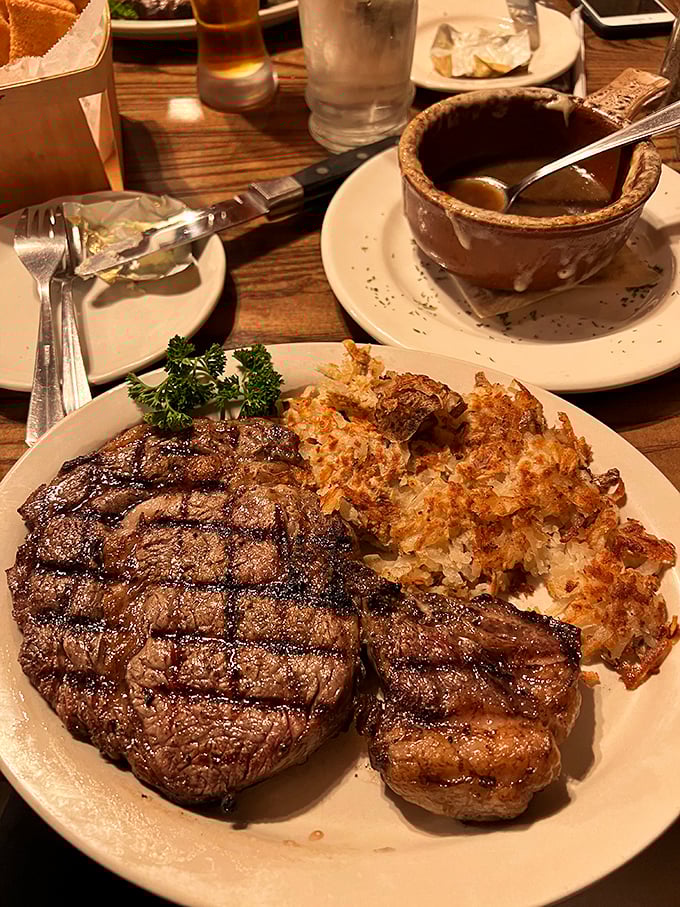 This isn't just a steak—it's a masterpiece with perfect grill marks, served with golden hash browns that shatter satisfyingly under your fork.