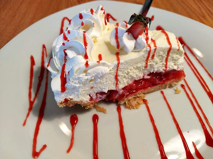 Strawberry cheesecake with a personality as bold as its presentation. Those red sauce drizzles aren't just for show—they're exclamation points at the end of a delicious sentence.
