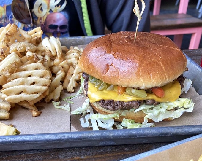 This isn't just a burger, it's an architectural achievement – layers of cheese, pickles and beef on a bun that somehow maintains structural integrity.
