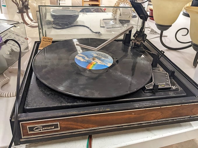 That vintage Garrard turntable isn't just playing records—it's spinning portals to decades when music was something you could hold.