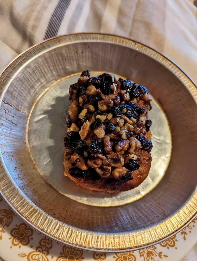 The walnut raisin roll—where fruit and nuts come together in cinnamon-spiced harmony. A sophisticated choice for those who appreciate texture in their indulgences.