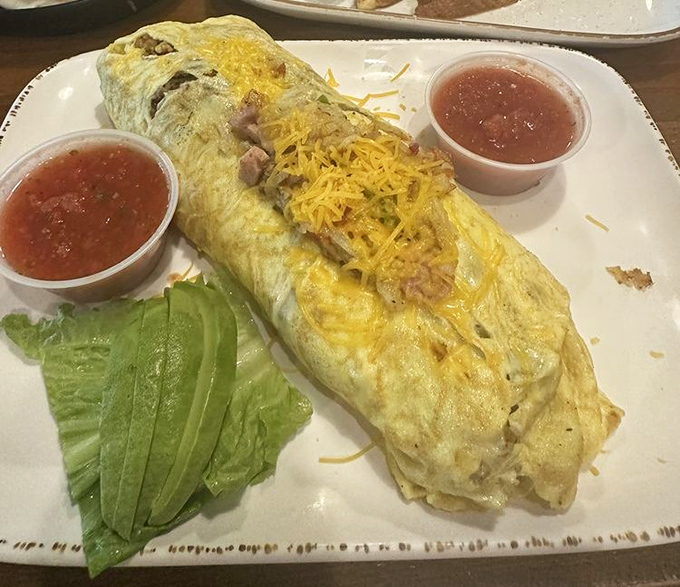 An omelet so stuffed with fillings it resembles a small pillow of breakfast joy, flanked by salsa that means business.