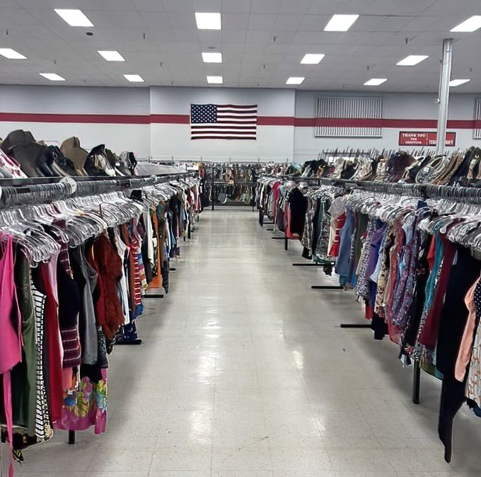The American flag watches over rows of potential wardrobe refreshes, silently approving your patriotic bargain hunting.