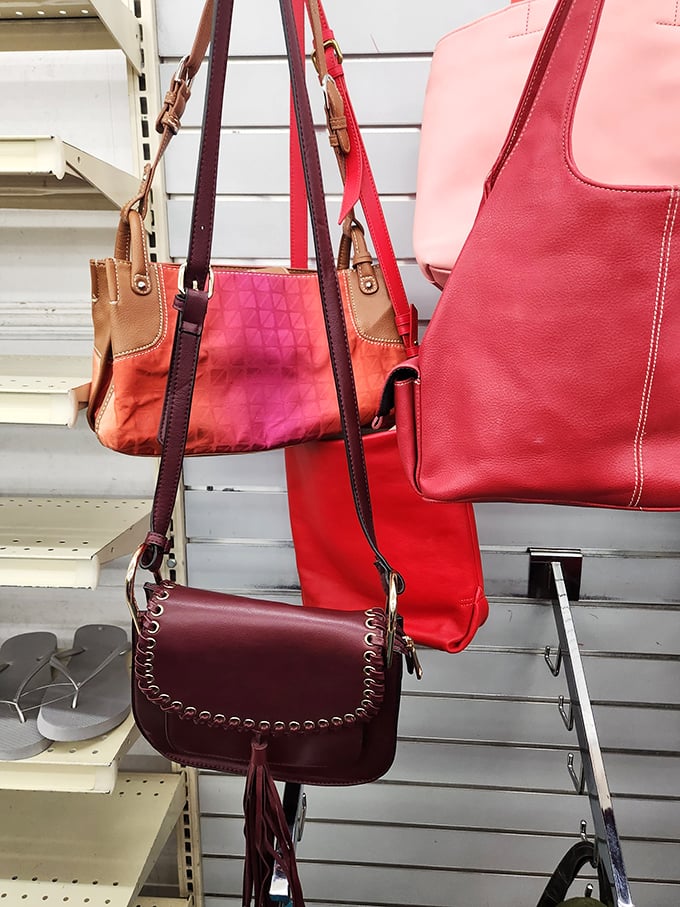 Handbags in shades of red and burgundy hanging like ripe fruit. These former arm candy companions are ready for new adventures and compliments.