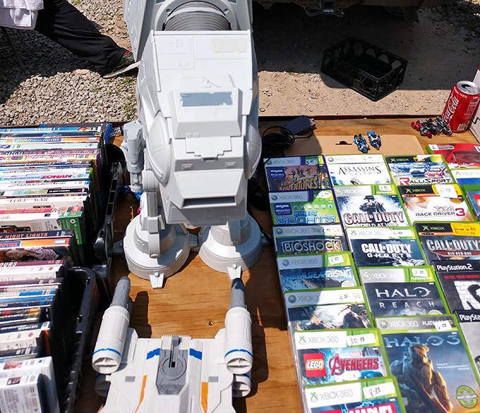 Video game archaeology at its finest—unearthing digital treasures from the Xbox 360 era while an AT-AT walker stands guard against imperial price hikes.