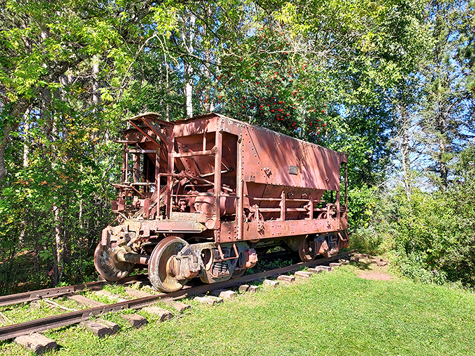 Industrial history on display: This rusted ore car represents the mining legacy that built Ironwood long before Hiawatha became its most famous resident.