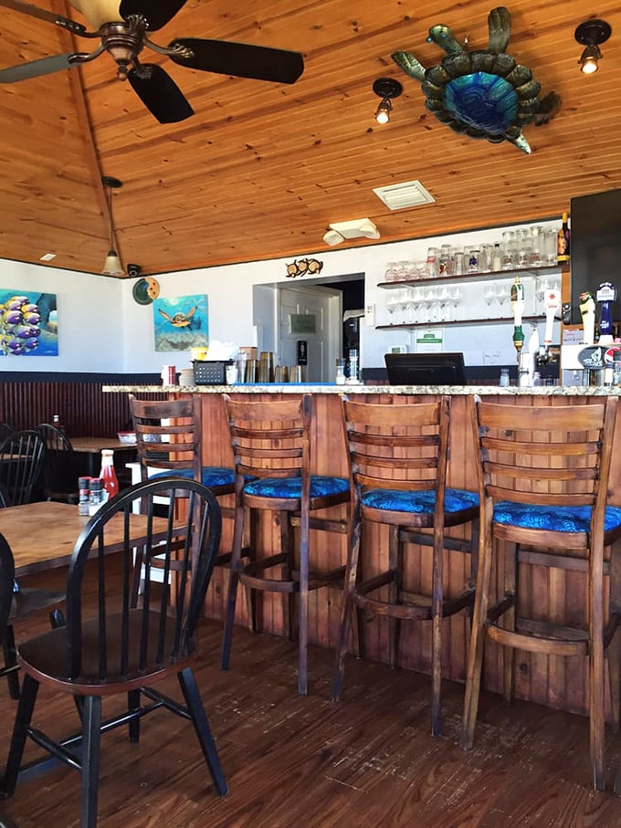 A bar that perfectly captures the "coastal casual" vibe, where wooden stools and ceiling fans tell you to relax—you're on Florida time now.