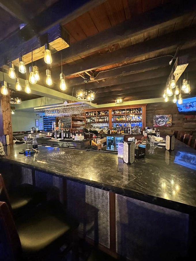 The bar isn't just where drinks are made—it's command central for liquid happiness. Edison bulbs cast a warm glow that makes everyone look like they're on vacation.