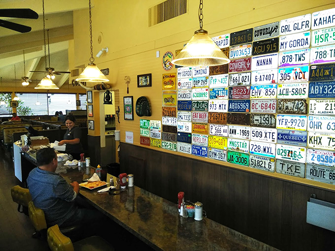 License plates line the wall like badges of honor from travelers who've discovered this breakfast oasis – each one telling a story of roads traveled.