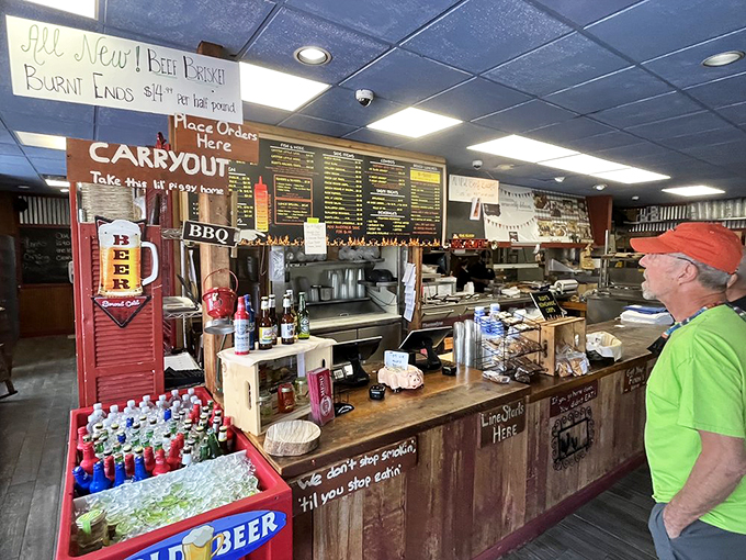 The ordering counter—where dreams are verbalized and hunger meets its match. Notice the "We don't stop cooking 'til you stop eating" sign? Challenge accepted.