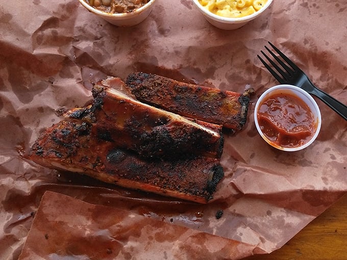 These ribs don't just fall off the bone—they practically leap onto your fork, leaving a trail of spice-crusted evidence on butcher paper below.
