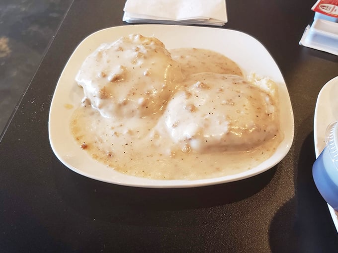 Biscuits drowning in creamy sausage gravy—a Southern breakfast tradition that demands to be eaten slowly and reverently.