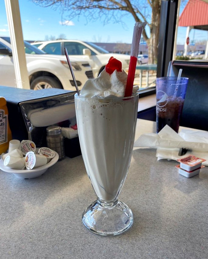 This isn't just a milkshake—it's a commitment. Topped with whipped cream and a cherry, it's dessert masquerading as a beverage.