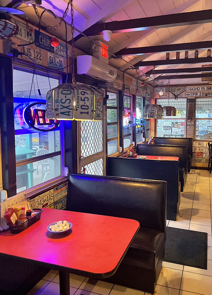 Cozy booths bathed in neon glow create the perfect setting for seafood feasts and vacation confessions.