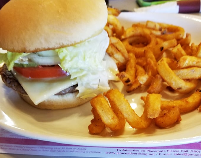 This isn't just a burger – it's a masterclass in simplicity with a perfectly toasted bun, fresh toppings, and fries that deserve their own fan club.