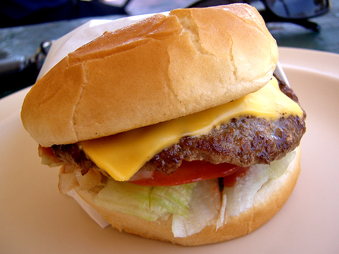 A classic cheeseburger that doesn't need fancy aioli or brioche buns to make its point—just fresh ingredients and proper execution.
