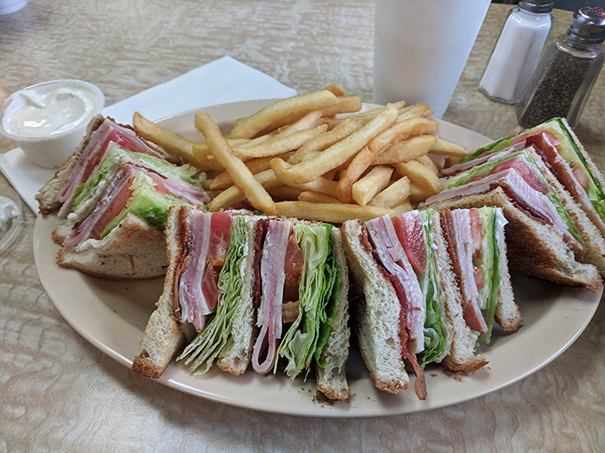 The club sandwich—triple-decker architecture that proves more is indeed more. Layers of meat, veggies, and toast create the skyscraper of sandwiches.