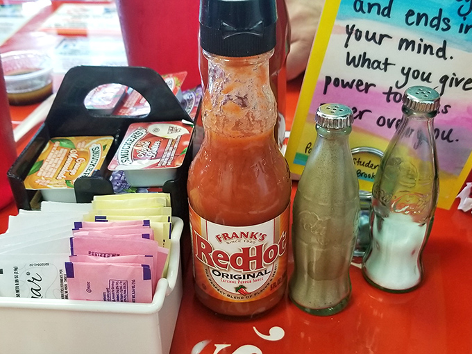 The condiment caddy—silent guardian of flavor customization, where hot sauce waits patiently for its moment to shine.