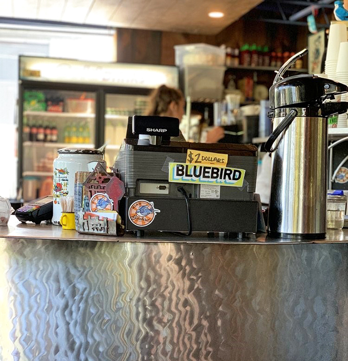 Where the magic happens—a register adorned with stickers and memories. The coffee's always fresh, the welcome always genuine.