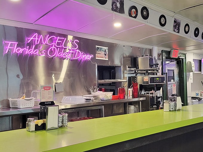 That neon sign isn't just decoration—it's a beacon of truth advertising "Florida's Oldest Diner" where the green counter has witnessed countless first dates and family breakfasts.