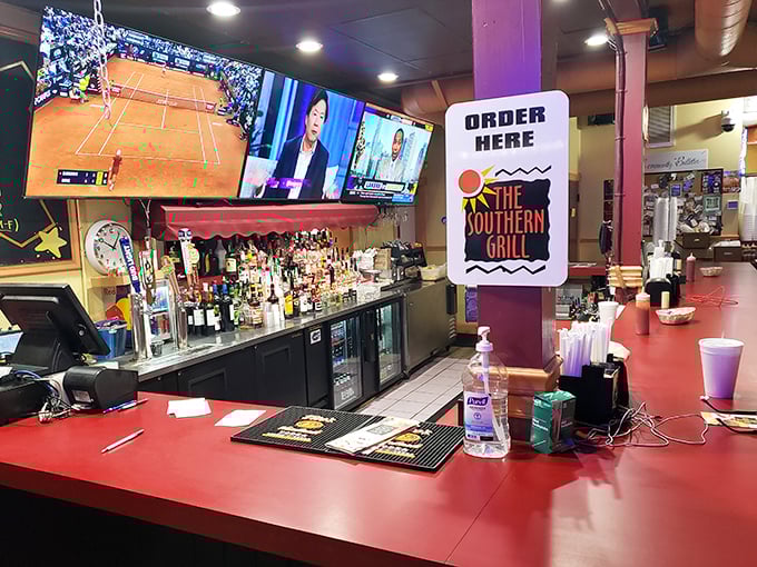 The bar's command center, where liquid happiness is dispensed with efficiency. Multiple TVs ensure you'll never miss a game while waiting for your Cuban sandwich masterpiece.