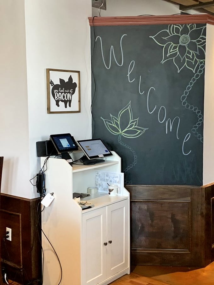 A welcome chalkboard that might as well say "Abandon all diets, ye who enter here" – with a pig sign that proudly endorses bacon consumption.
