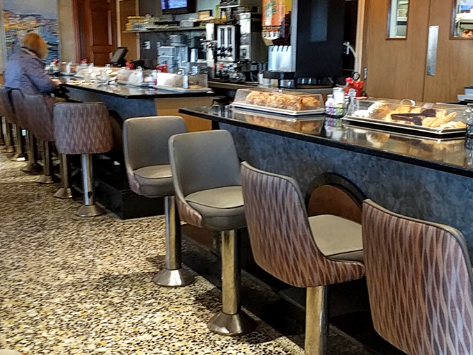 Counter culture at its finest—where early birds perch with coffee and pastries, watching the morning unfold in delicious real-time.