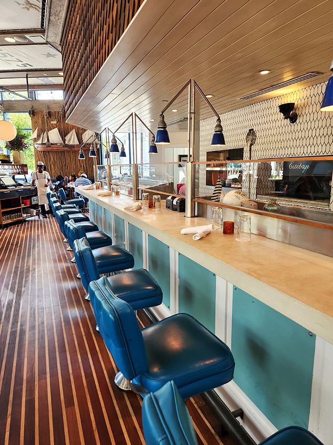 Blue bar stools line up like eager sailors, inviting you to belly up for front-row views of oyster-shucking action and cocktail choreography.