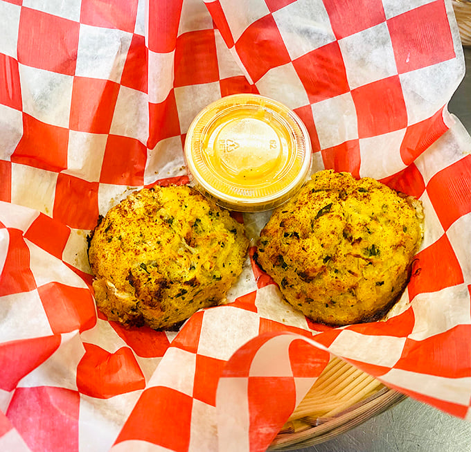 Golden-brown crab cakes nestled in their checkered cradle. These seasoned spheres of crabby goodness are the handheld heroes of the seafood world.