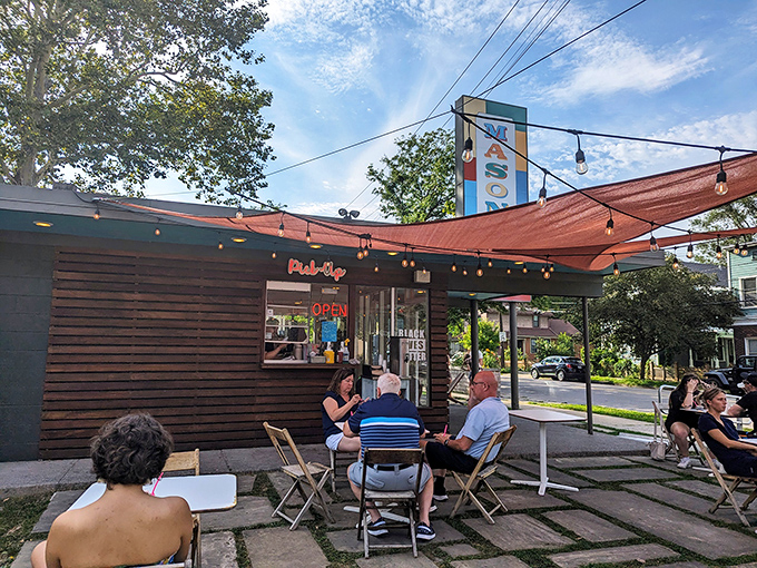 The outdoor seating area becomes Cleveland's most democratic space—where strangers connected by nothing but great taste share summer evenings and frozen treats.
