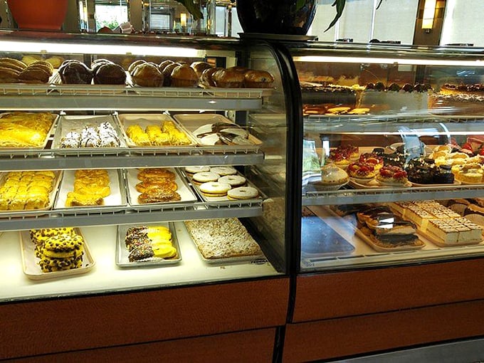 The dessert case doesn't just display sweets—it exhibits edible art that makes willpower crumble faster than their perfect pie crusts.