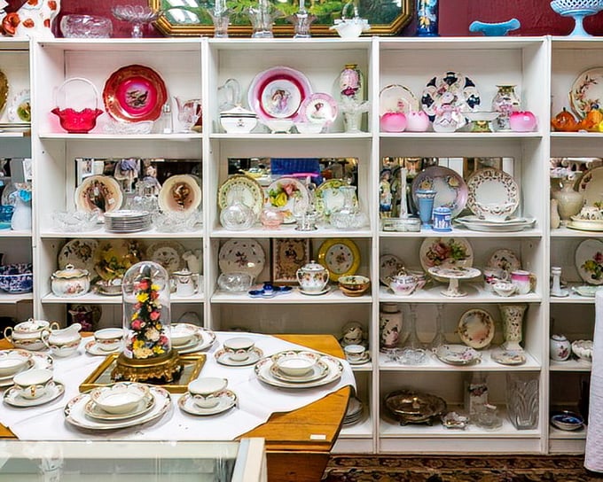 White shelves showcasing fine china and crystal—because before we had Instagram to display our taste, we had dining room hutches. 