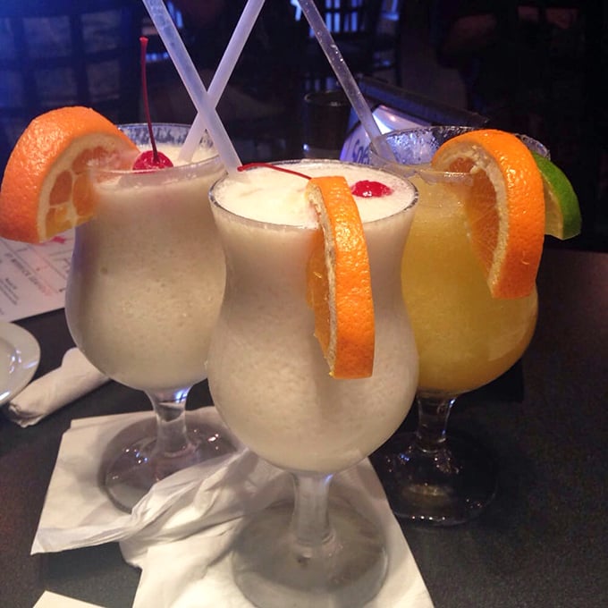 Tropical cocktails that transport you to island time with just one sip. Those orange spirals aren't just garnish—they're exclamation points on liquid vacation.