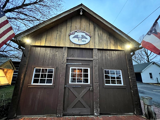 As evening falls, the tavern's exterior glows with invitation. That wooden door has welcomed more hungry travelers than a highway rest stop—but with infinitely better food.