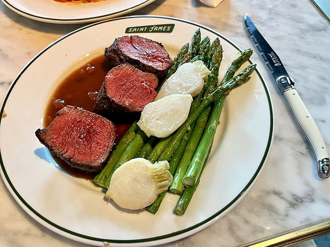 This steak doesn't just sit on the plate—it commands attention, while asparagus and potatoes play supporting roles to perfection.