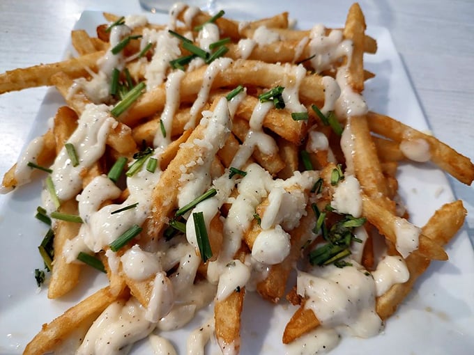 These aren't just fries—they're a delivery system for creamy aioli and fresh herbs. Potatoes reaching their highest potential.