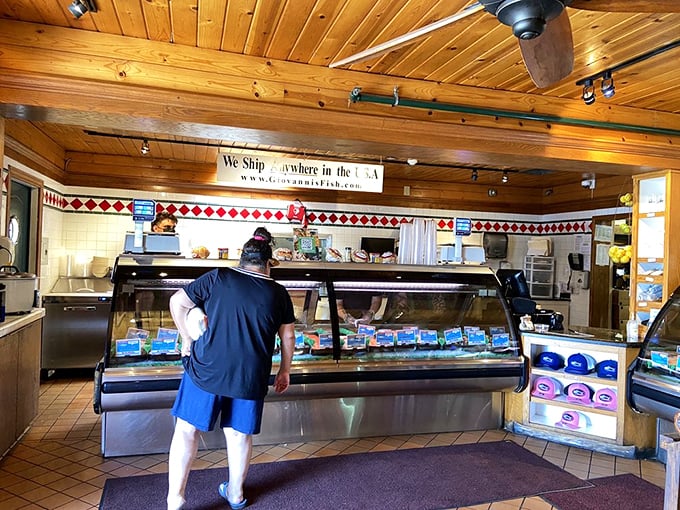 The fish counter—where dreams and dinner plans converge. "We ship anywhere in the USA" isn't just a sign—it's a promise of seafood democracy.