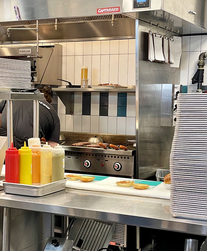 Through the kitchen window, you can glimpse the serious business of burger crafting happening with professional-grade equipment and genuine care.