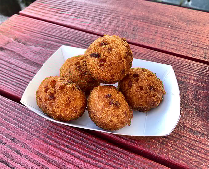 Hush puppies with the perfect golden crunch—crispy outside, tender inside. These little spheres of cornmeal joy are what happens when fritters fulfill their destiny.