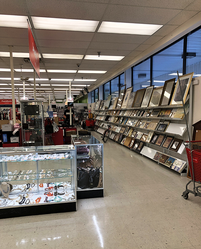 Value Village's jewelry counter and frame section—where someone else's memories become your new treasures.