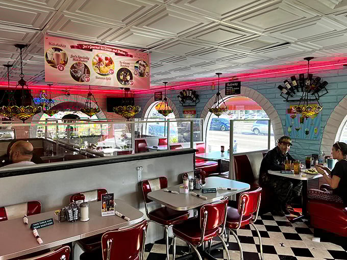The interior glows with neon warmth as Tiffany-style lamps cast a gentle light over diners enjoying their meals—nostalgia you can eat in.