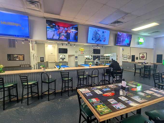 The bar area: where sports on TV meet cold beer and hot food. Those high-backed chairs aren't just seating—they're invitations to stay awhile.