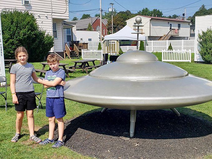 Young explorers investigate the spacecraft's landing site, perhaps planning their own future missions to the stars.