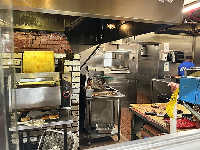 The kitchen—where smoke meets meat in a dance choreographed by decades of tradition and unwavering standards. 