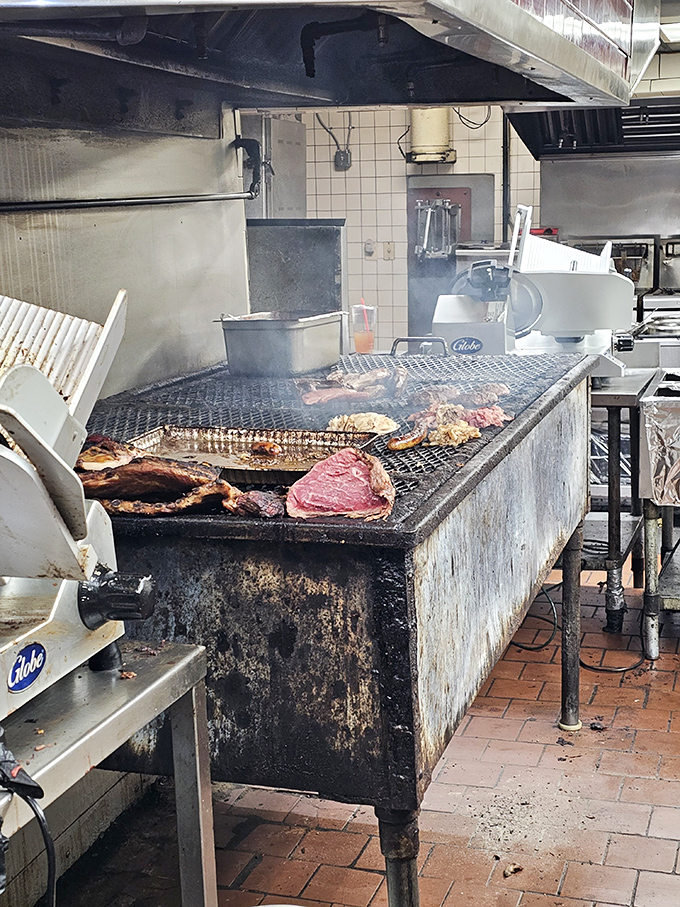 Behold the pit – that smoky, well-seasoned altar where meat transforms from ordinary to extraordinary. This isn't cooking; it's alchemy with fire and time.