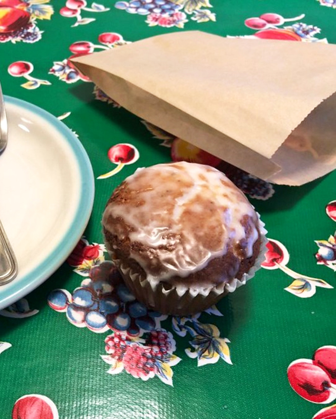 A glazed muffin sits ready for adventure, proving that not all great things here come in pie form.
